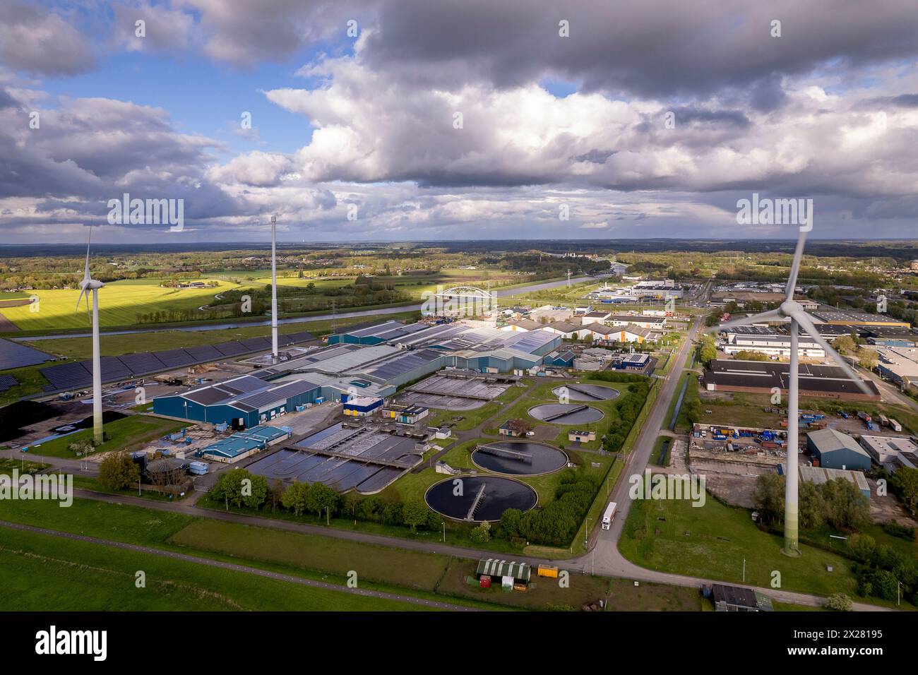 Wind turbine closeup and water treatment and bio energy facility ...