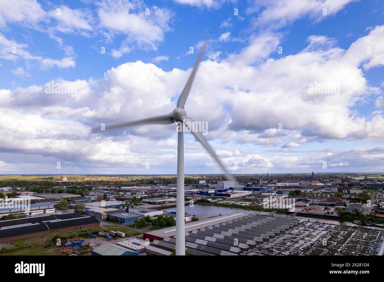 Wind turbine closeup and water treatment and bio energy facility ...
