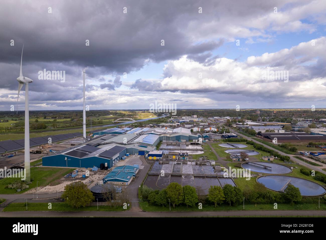 Wind turbine closeup and water treatment and bio energy facility ...