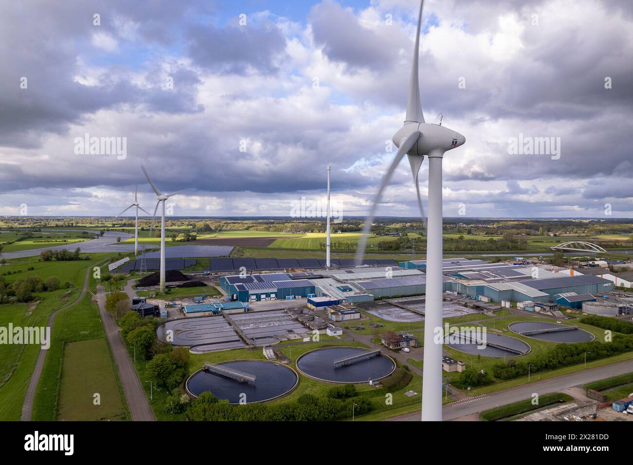 Wind turbine closeup and water treatment and bio energy facility ...