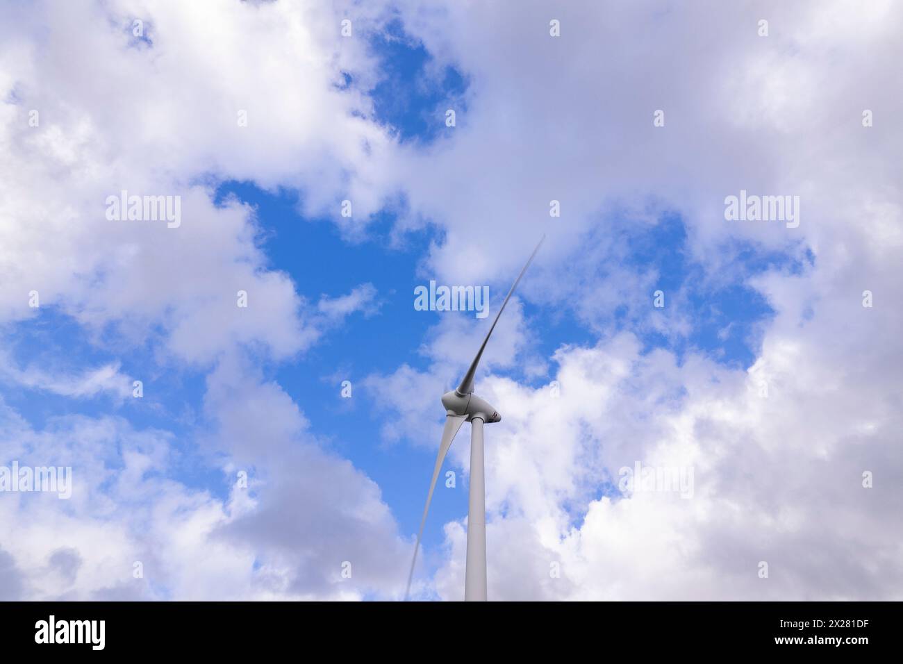 Wind turbine closeup and water treatment and bio energy facility ...