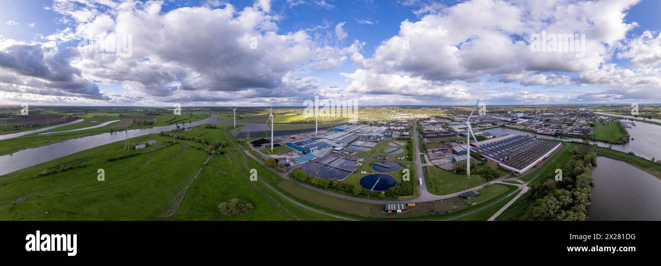 Wind turbine closeup and water treatment and bio energy facility ...