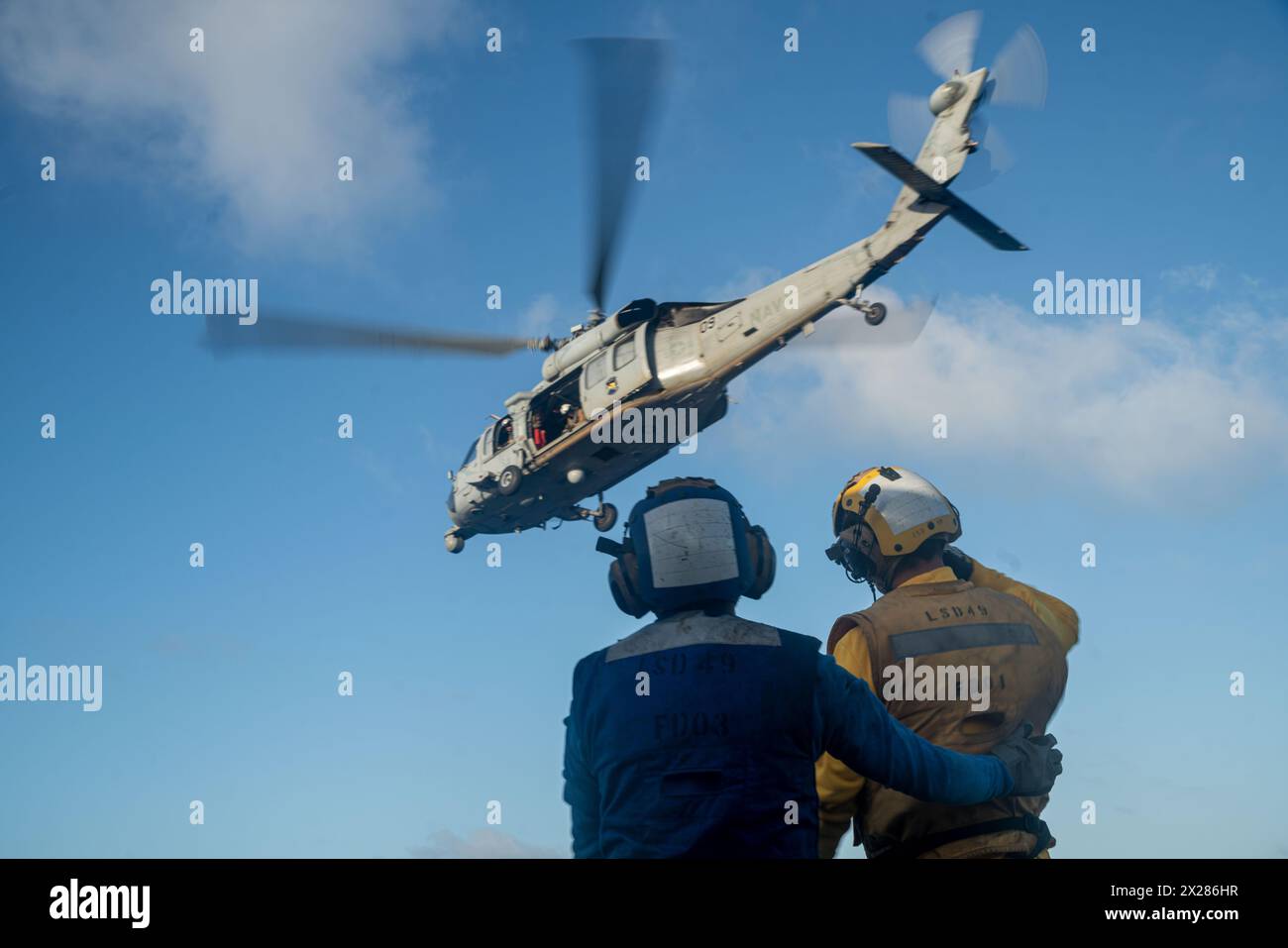 U.S. Sailors assigned to the amphibious dock landing ship USS Harpers ...