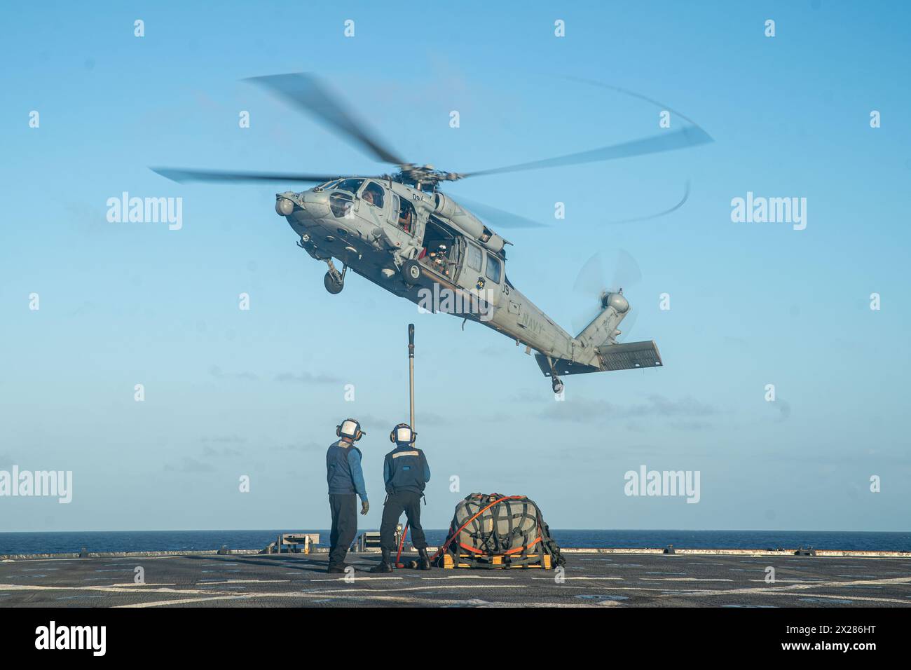 U.S. Sailors assigned to the amphibious dock landing ship USS Harpers ...