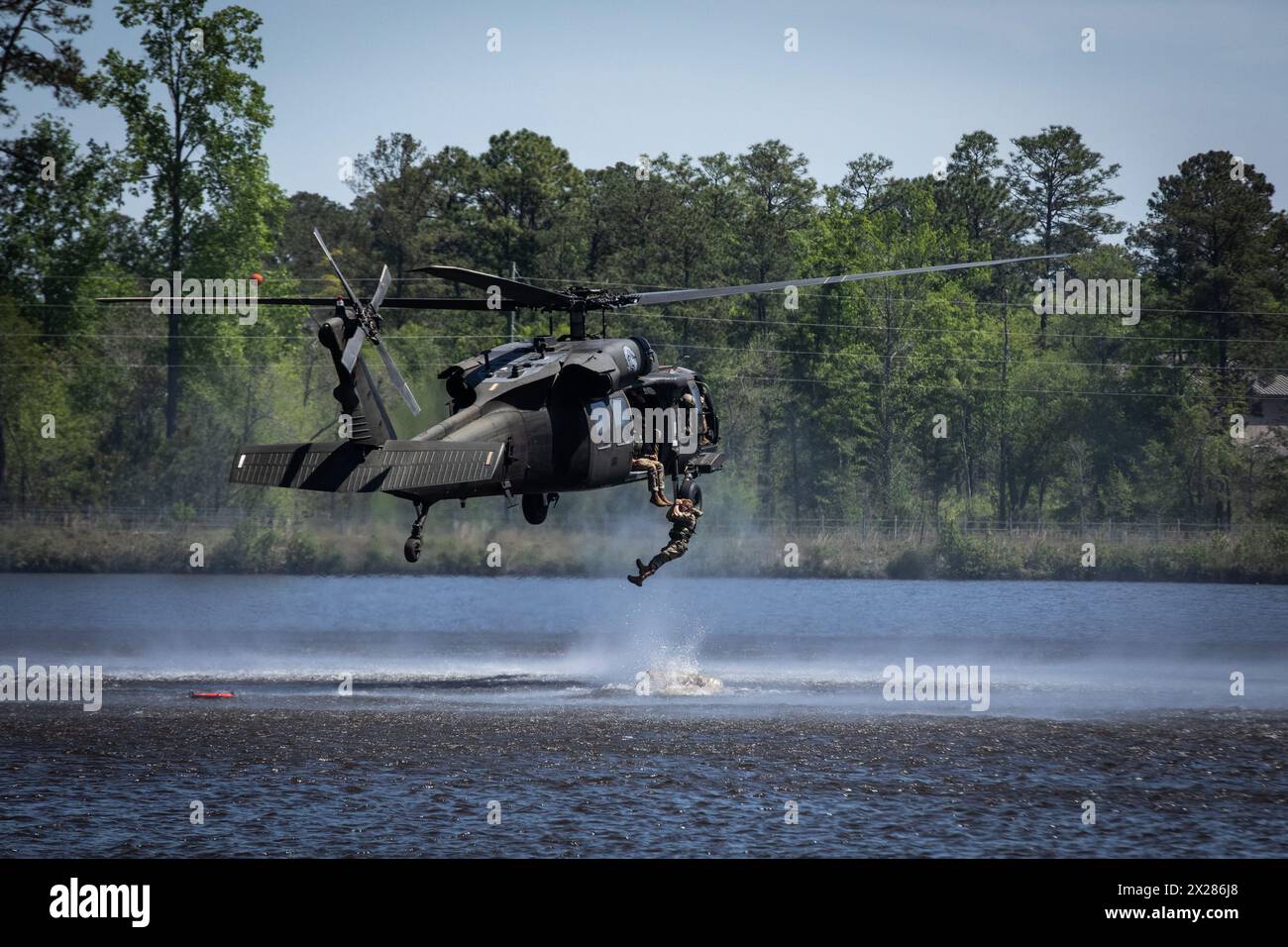 Two U.S. Army Soldiers exit a UH-60 Blackhawk helicopter into Victory ...