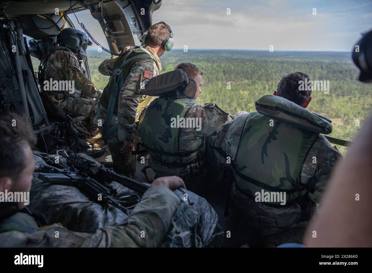 A group of U.S. Army Soldiers wait in anticipation to Helocast into a ...