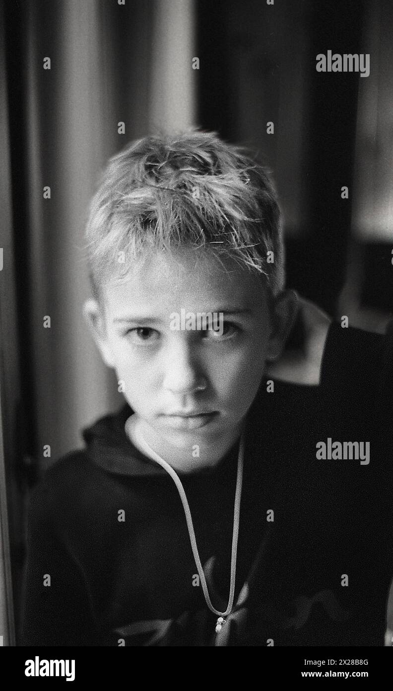 Head and shoulders portrait of teen boy, serious expression Stock Photo ...