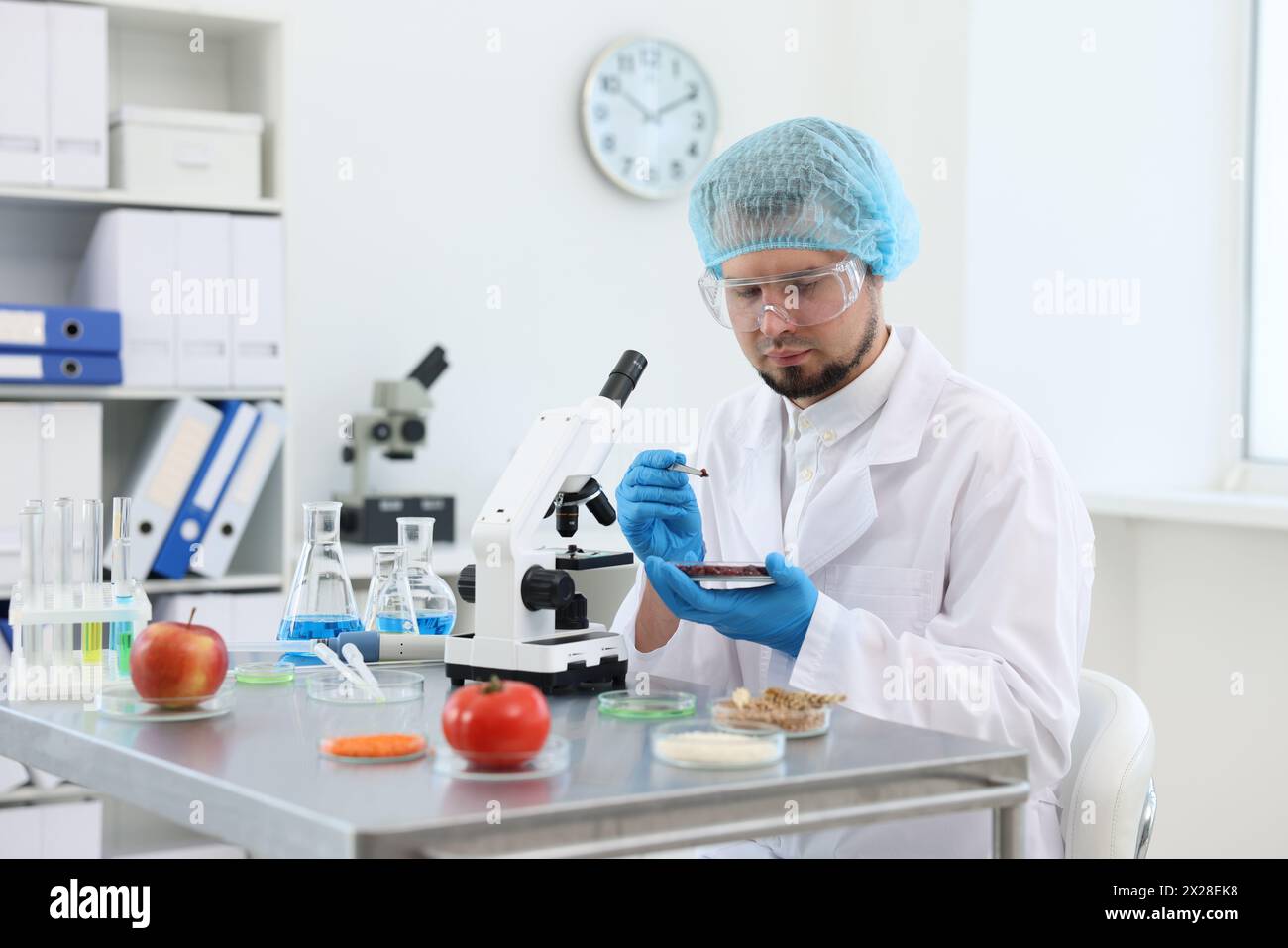 Quality control. Food inspector checking safety of products in ...