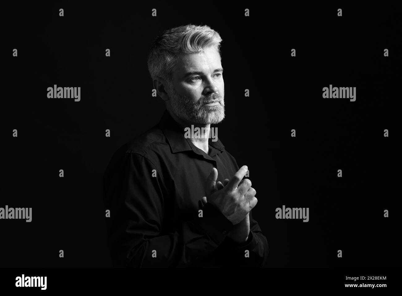 Portrait of handsome man on dark background. Black and white effect ...