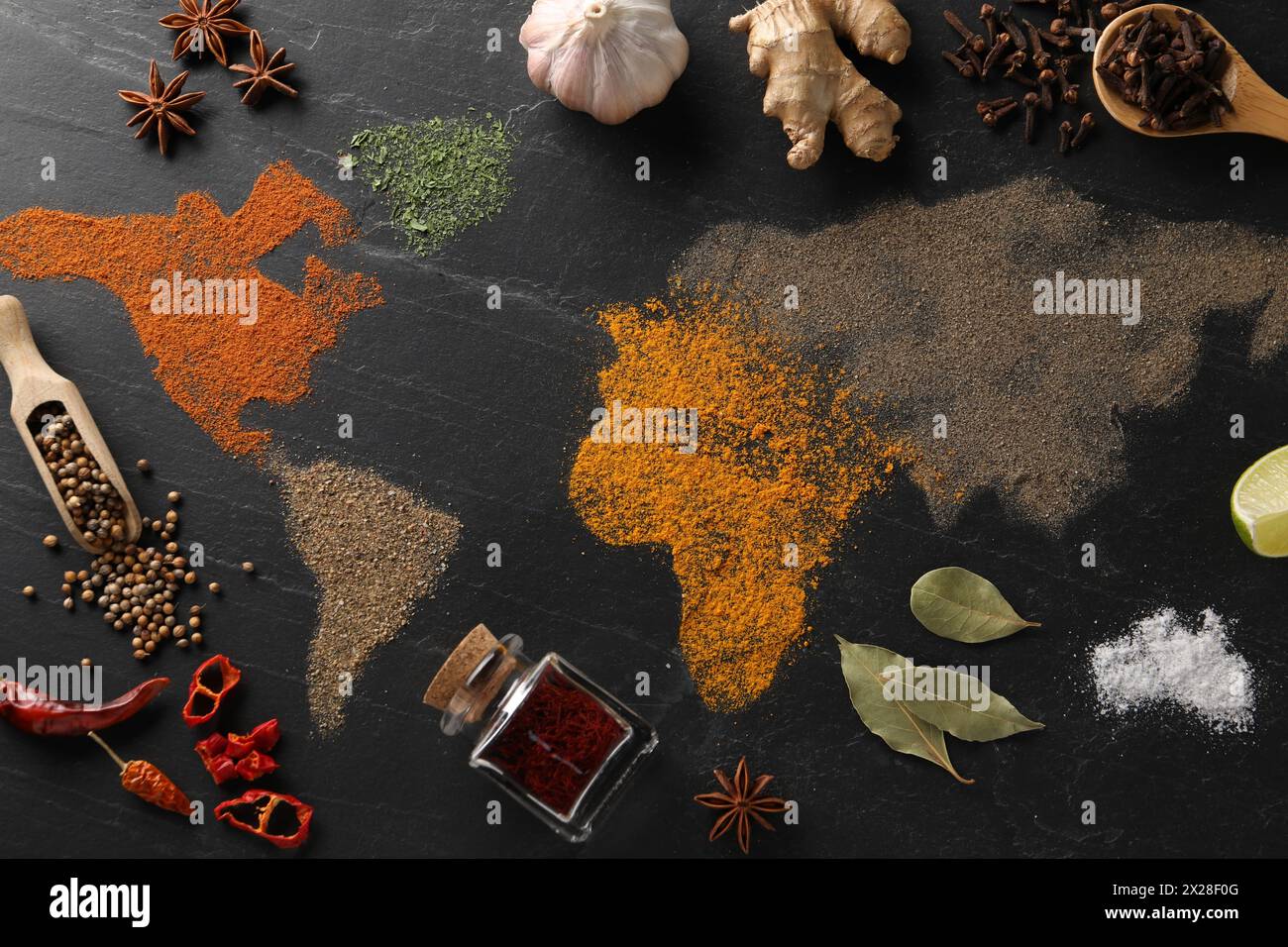 World map of different spices and products on dark textured table, flat ...