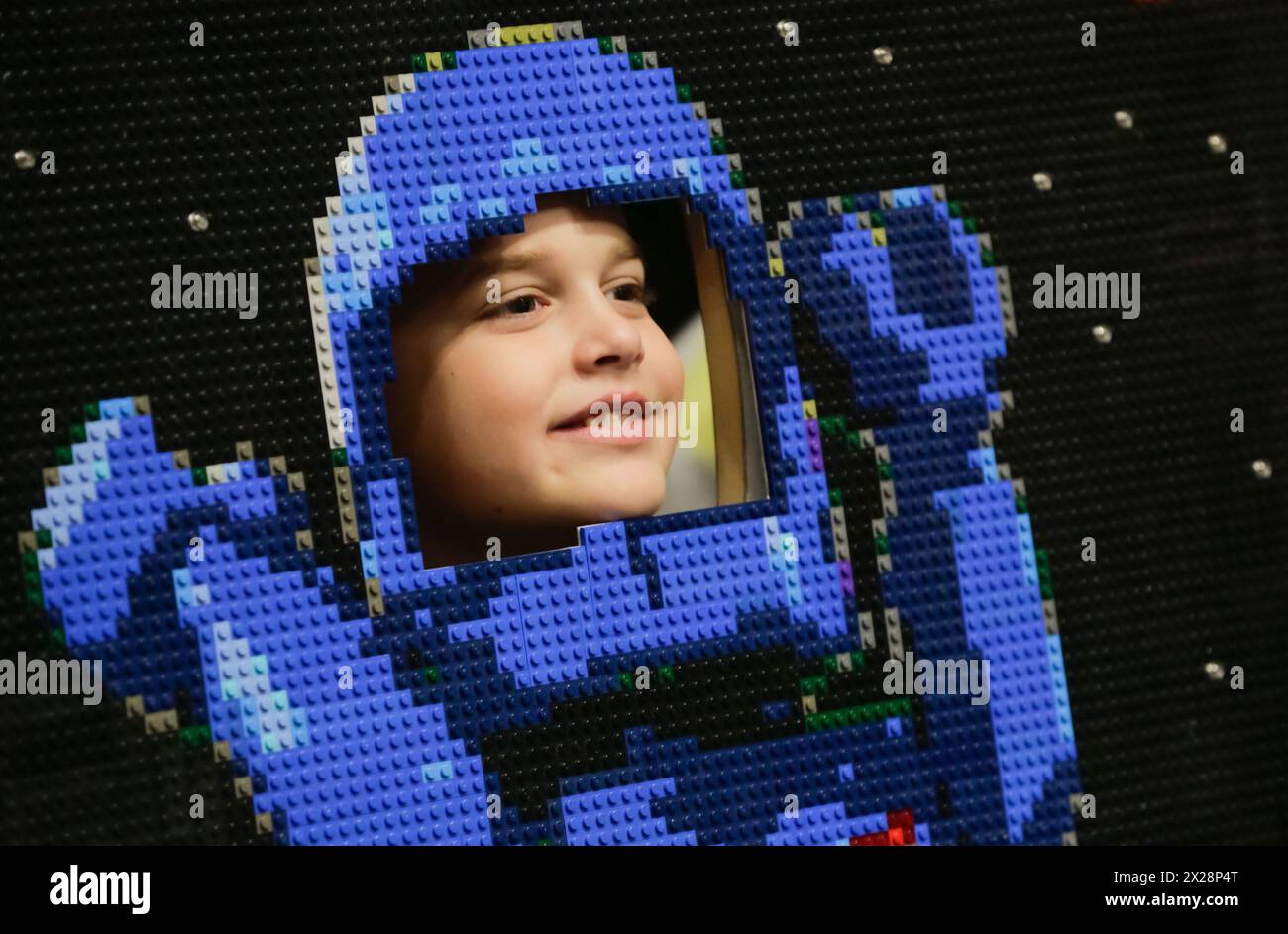 Richmond, Canada. 20th Apr, 2024. A boy poses for photos behind a LEGO ...