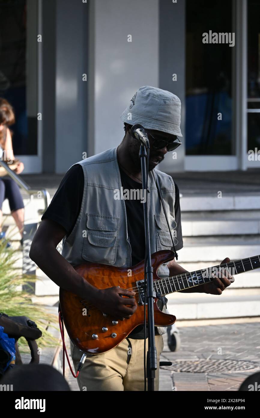Black musician playing guitar on the street in Victoria and Alfred ...