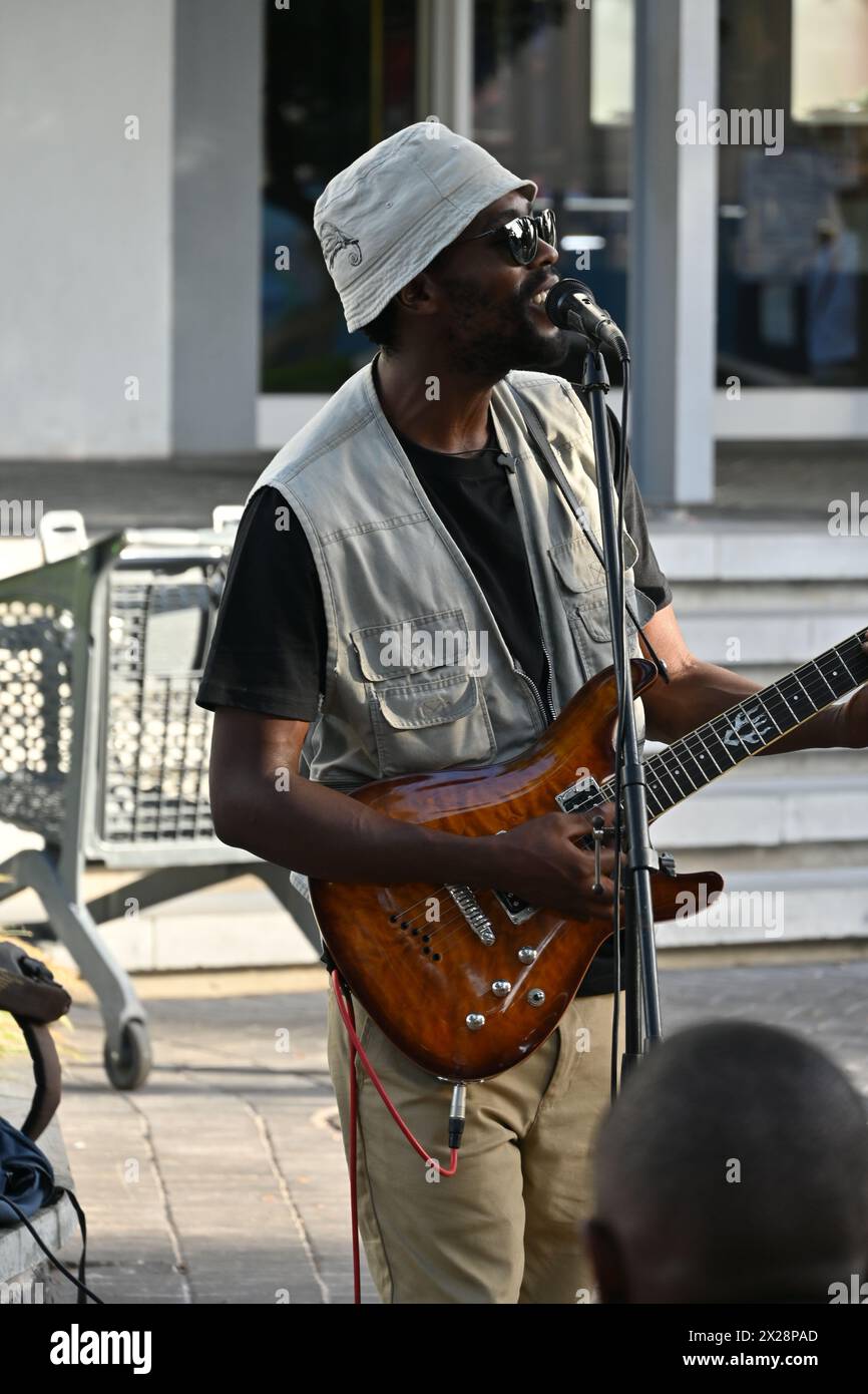 Black musician playing guitar on the street in Victoria and Alfred ...