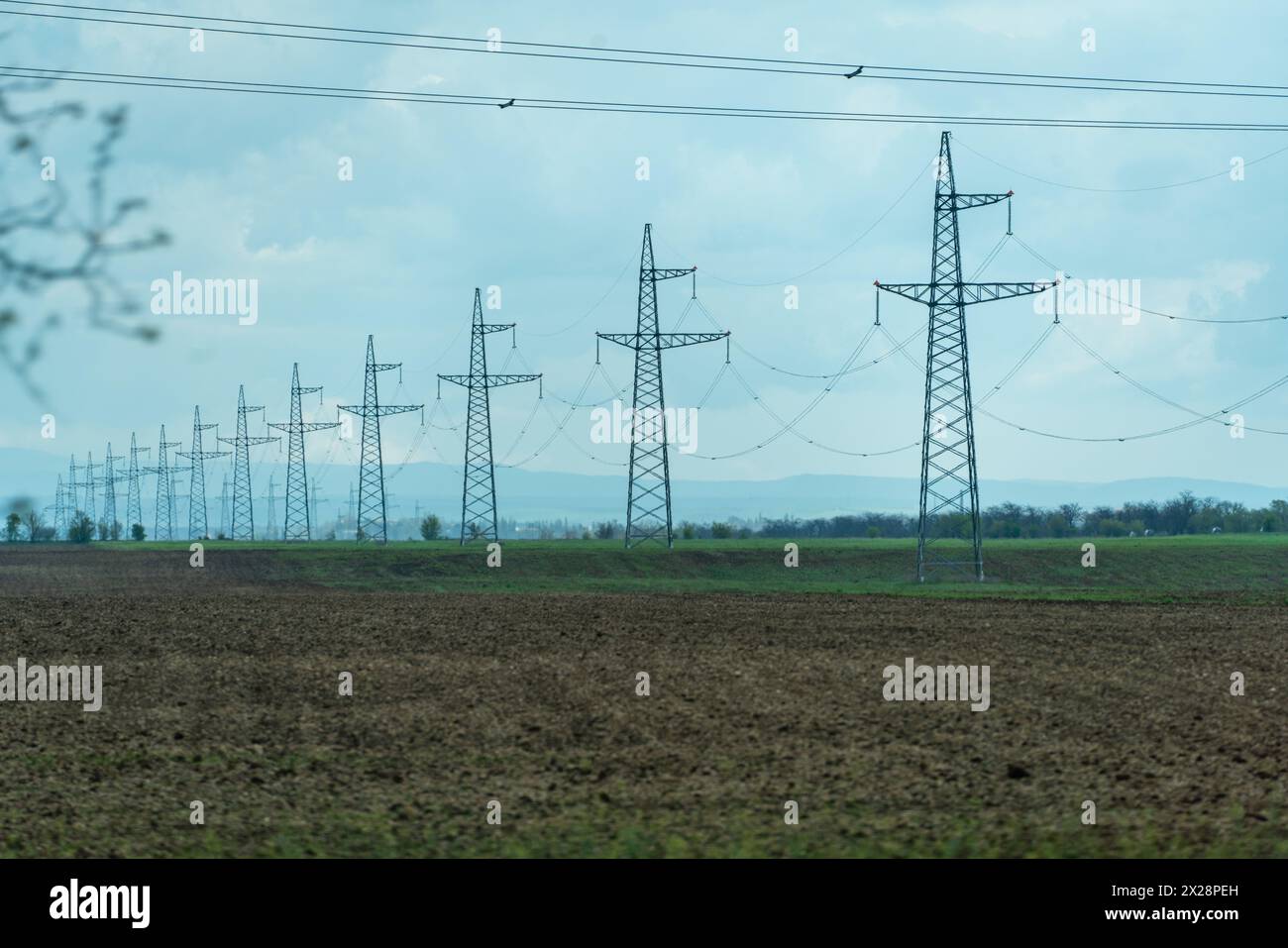 High voltage towers with sky background. Power line support with wires ...