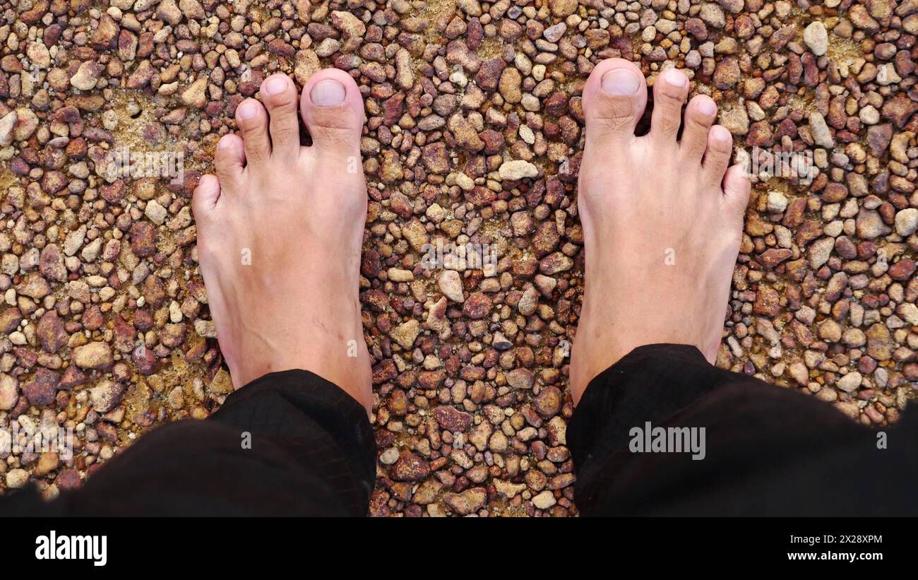 Feet walking he bags of gravelly soil. Ecological concept, unity with ...