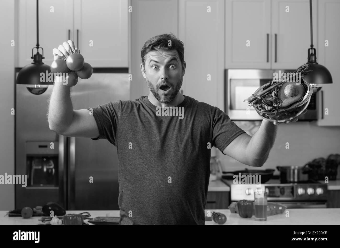 Middle aged man cooking in kitchen. Man on kitchen with vegetables ...