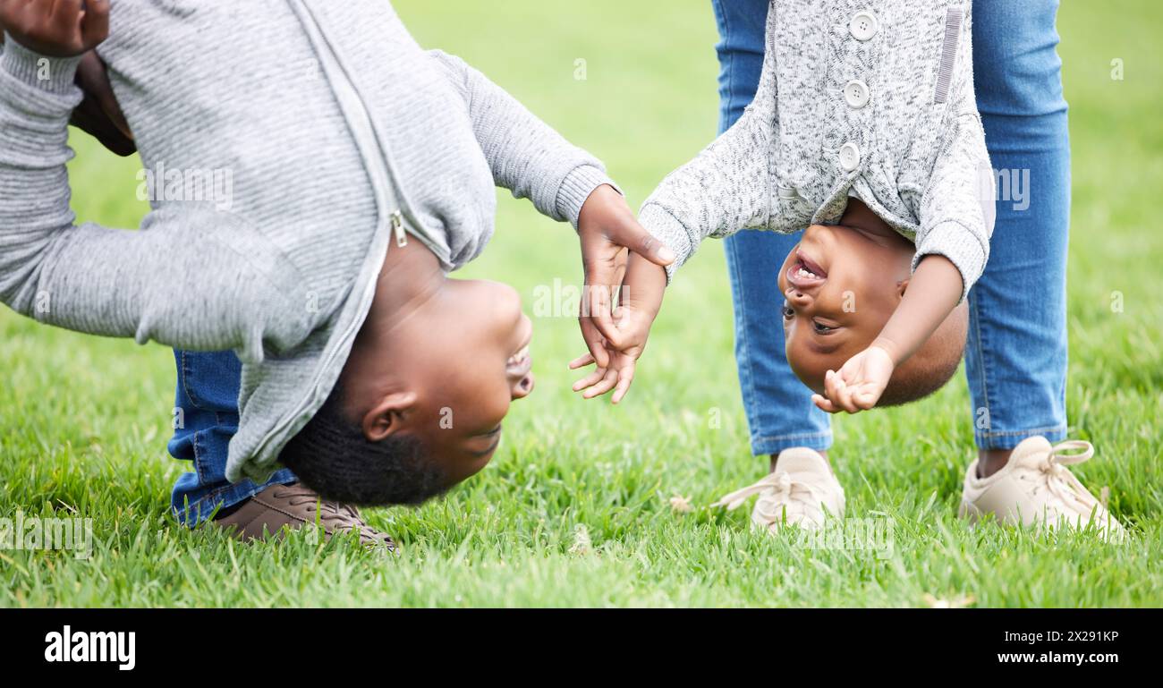 Parents, kids and upside down for swing, laughing and bonding with care ...