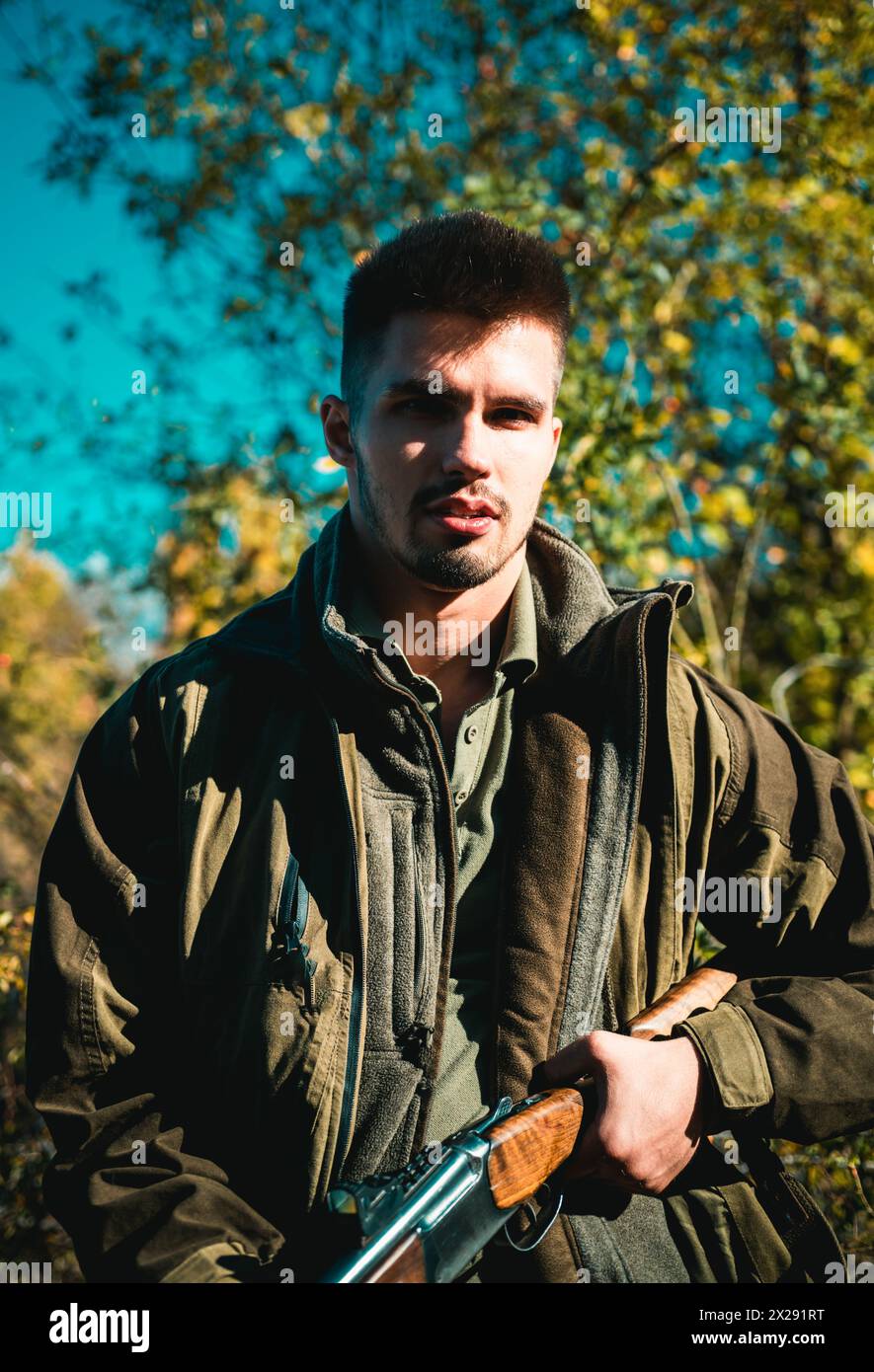 Hunter with shotgun gun on hunt. Close up Portrait of hamdsome Hunter ...