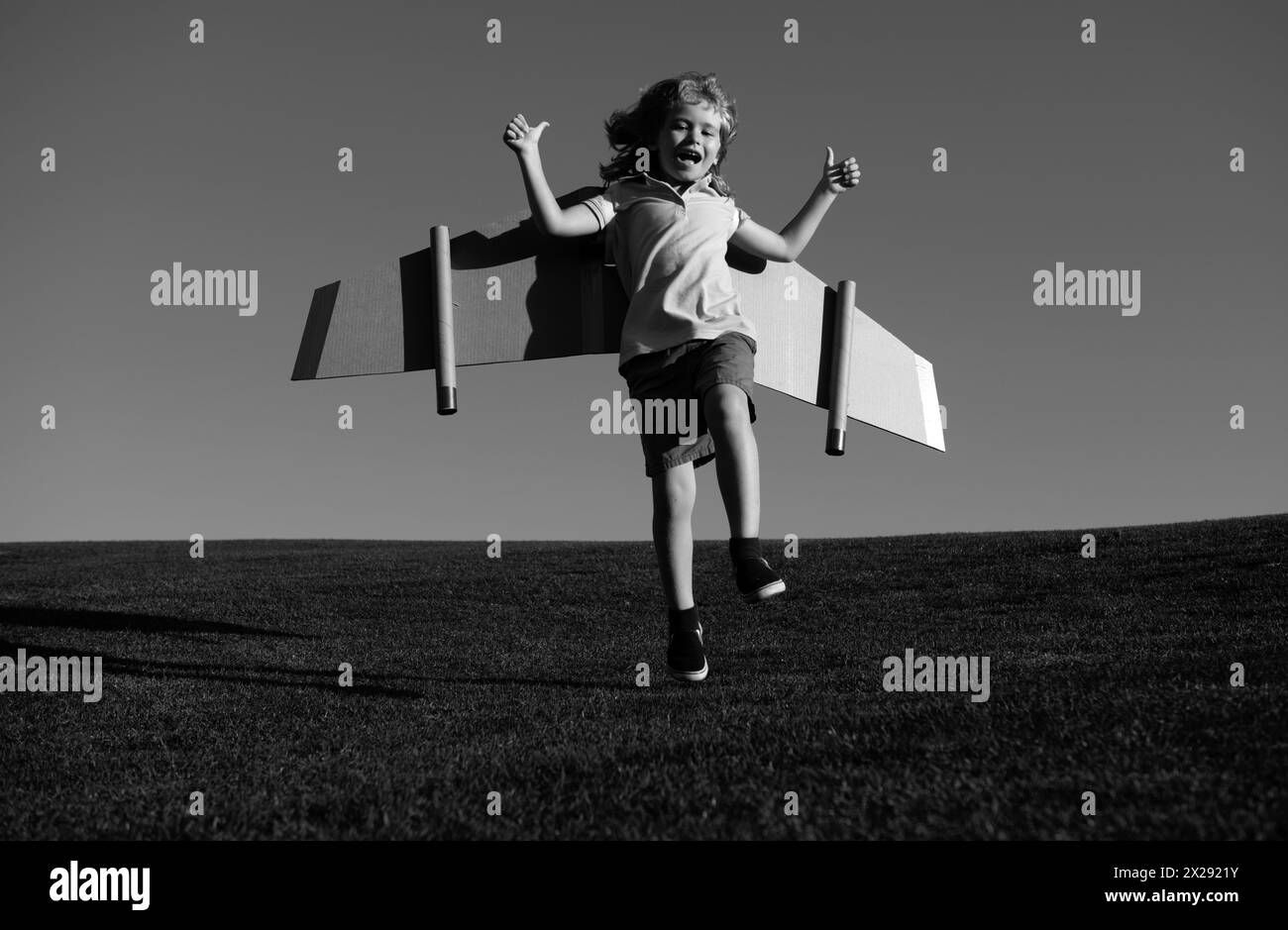 Child boy dreams and travels. Boy jumping and running with airplane toy ...