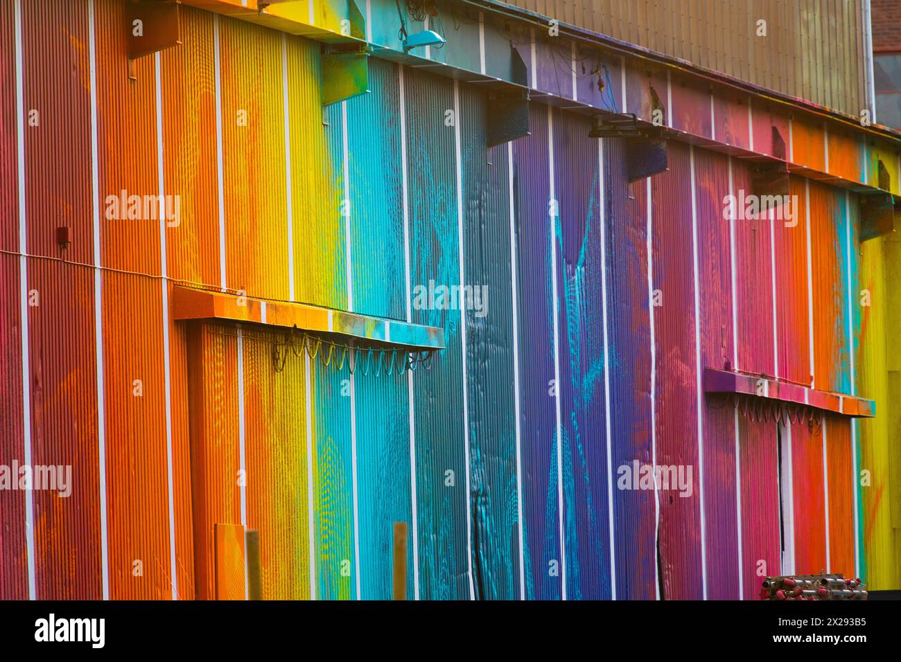 Rainbow colour painted port of a large warehouse Stock Photo - Alamy