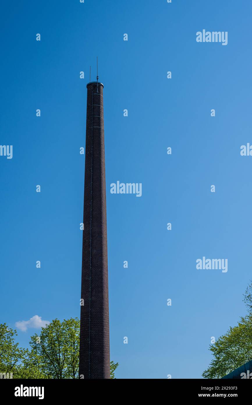 Tall smoke stack on blue sky Stock Photo - Alamy