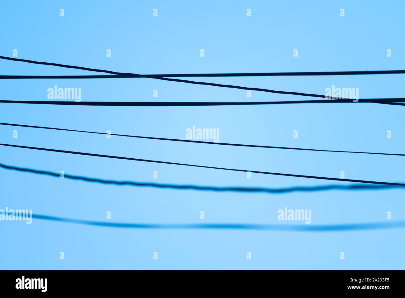 Power lines hanging between poles Stock Photo - Alamy