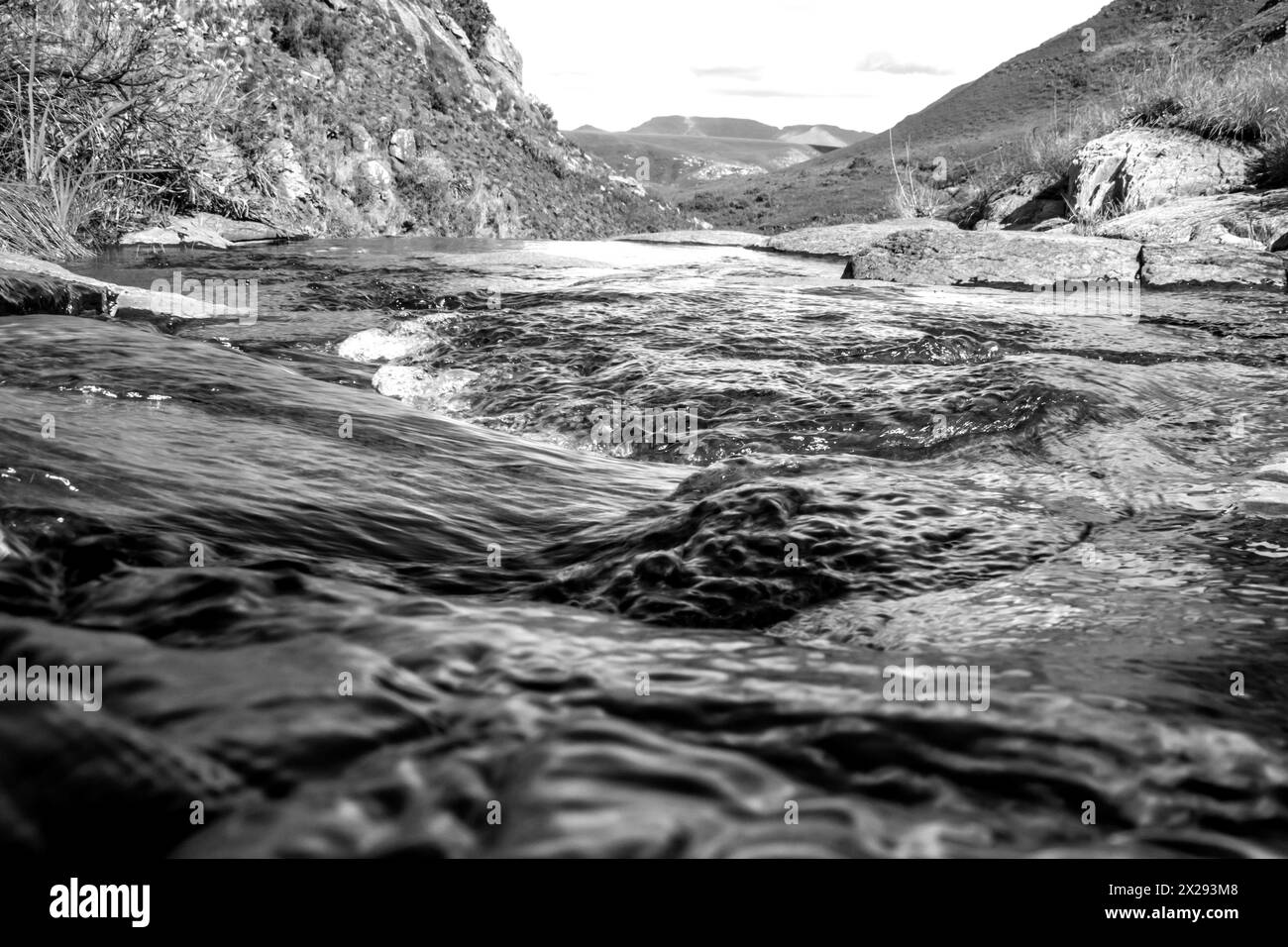 View over a small stream, just before it drops of, at the edge of a ...