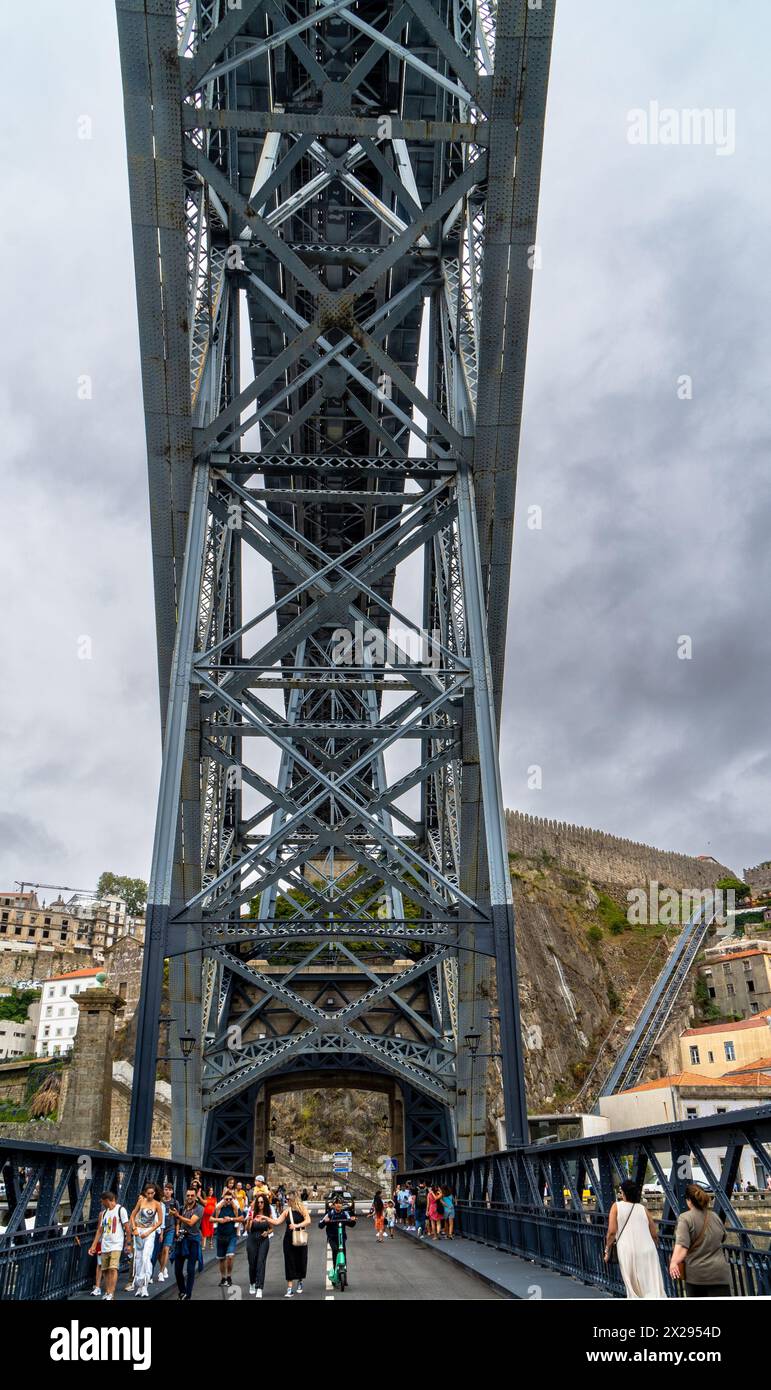 Tourists walking along the lower platform with a view of the metal ...
