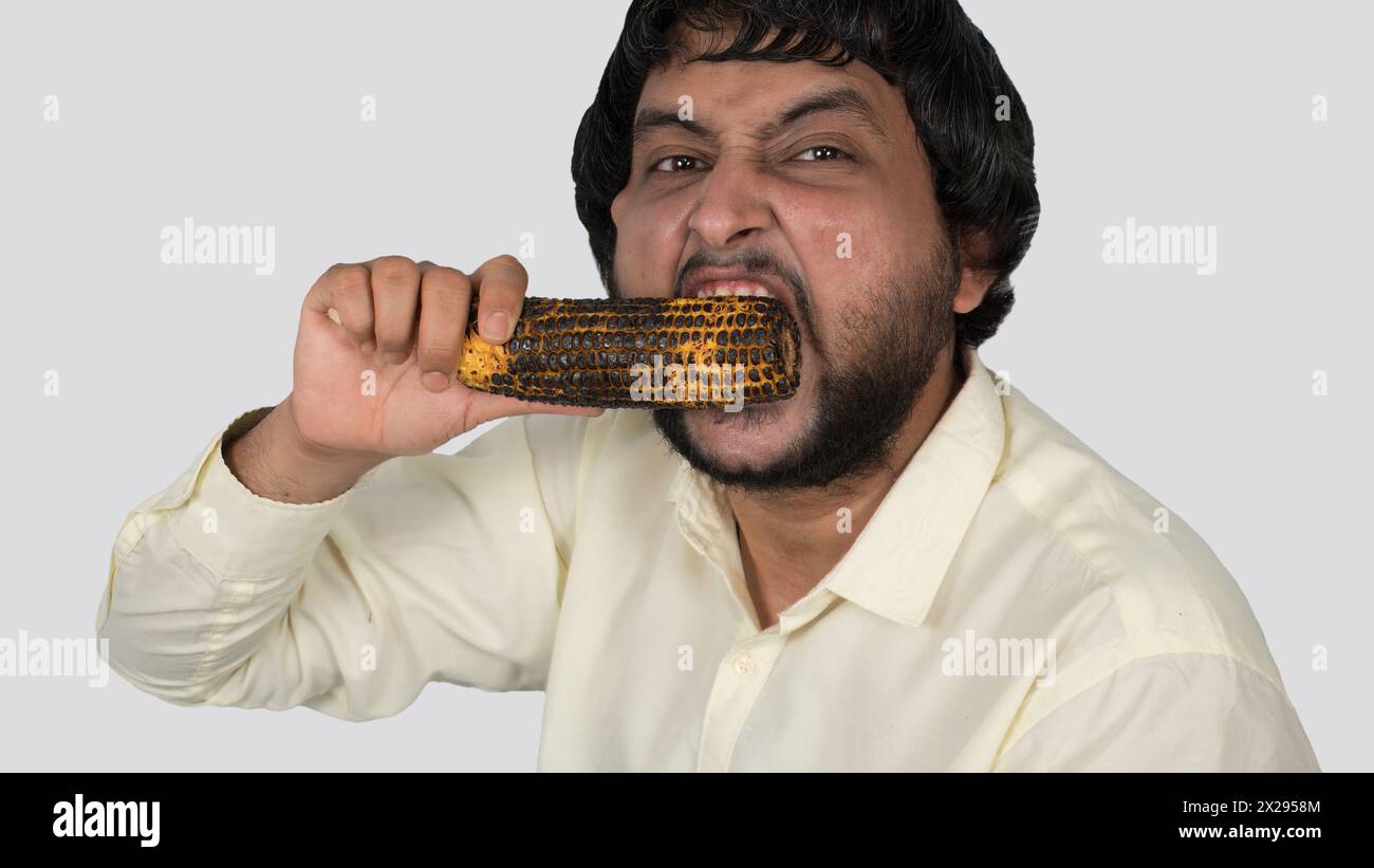 Close-Up View of a young boy eating corn cob like crazy way facial ...