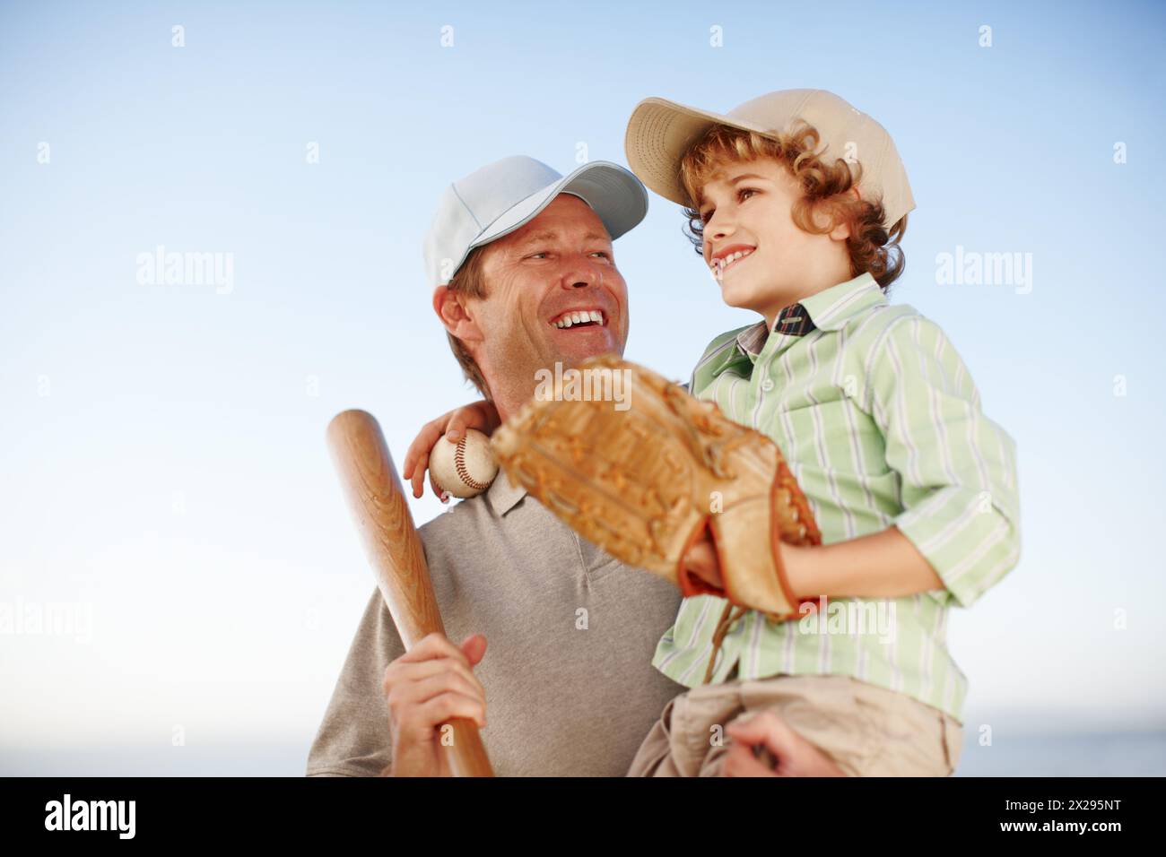 Father, boy and happy for baseball, outdoor and game with hug for love ...
