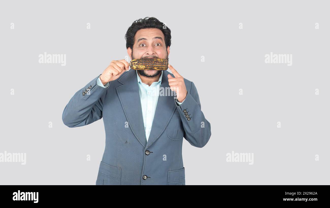 a young boy eating corn cob with amazing facial expressions of eating ...