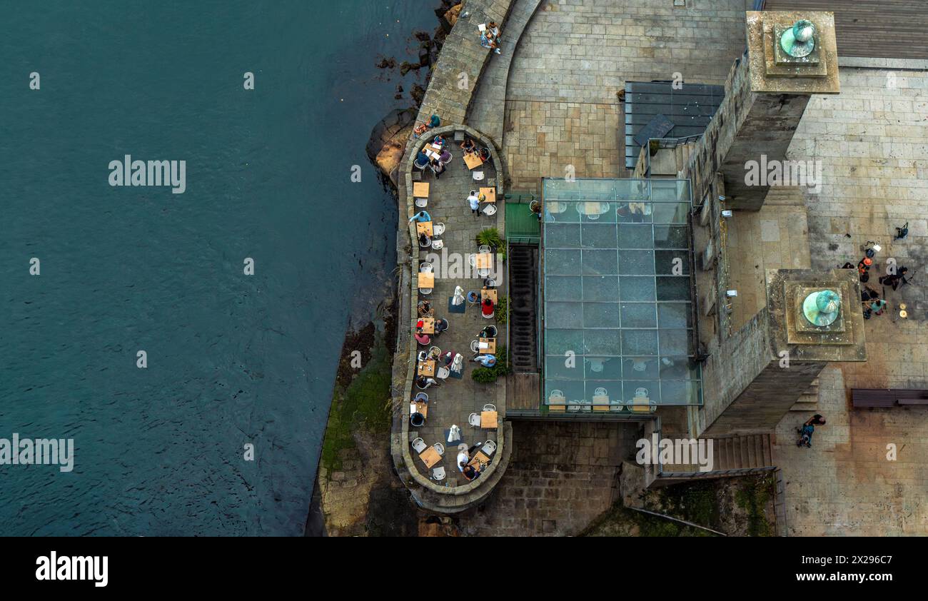 Aerial overhead view of people sitting at square tables and chairs on ...