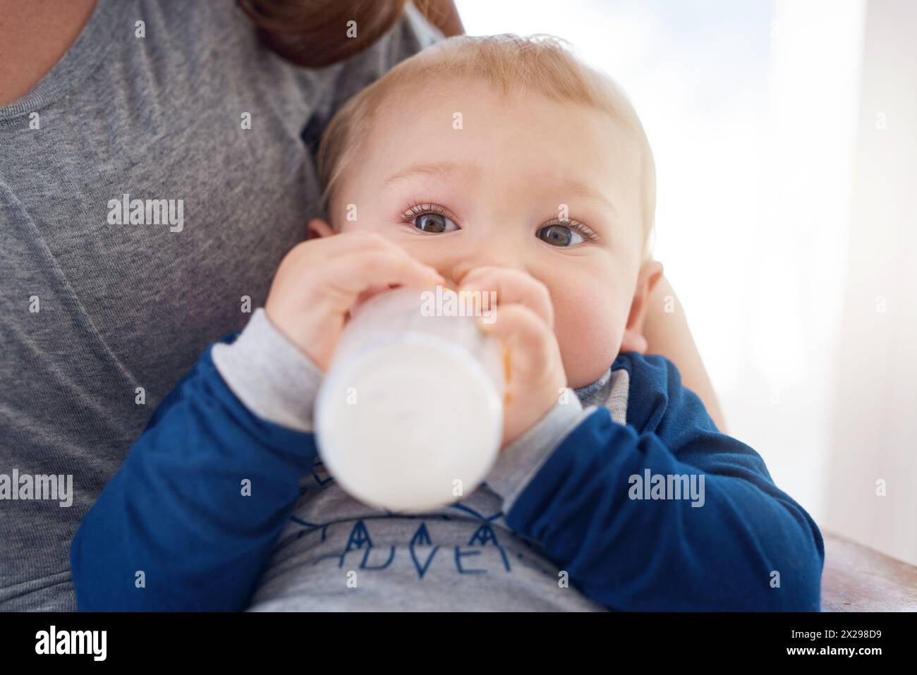 Mother, child and feeding with milk, bottle and motor skills for ...