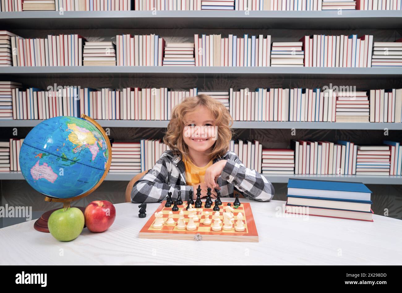 Child play chess in classroom at school. Clever concentrated and ...