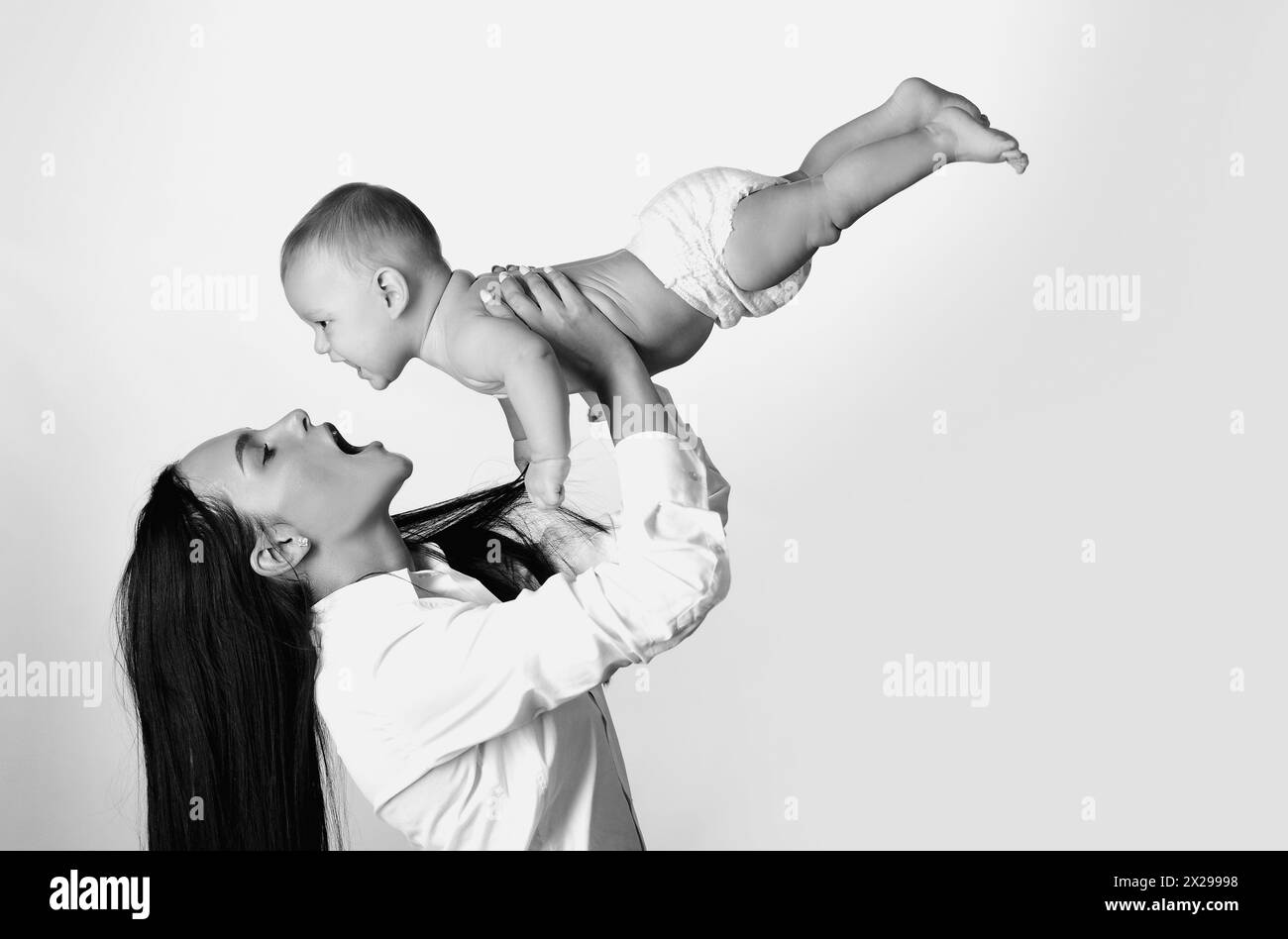 Mother hug. Closeup studio portrait of mother and baby child isolated on whtite. Mother hugging ...