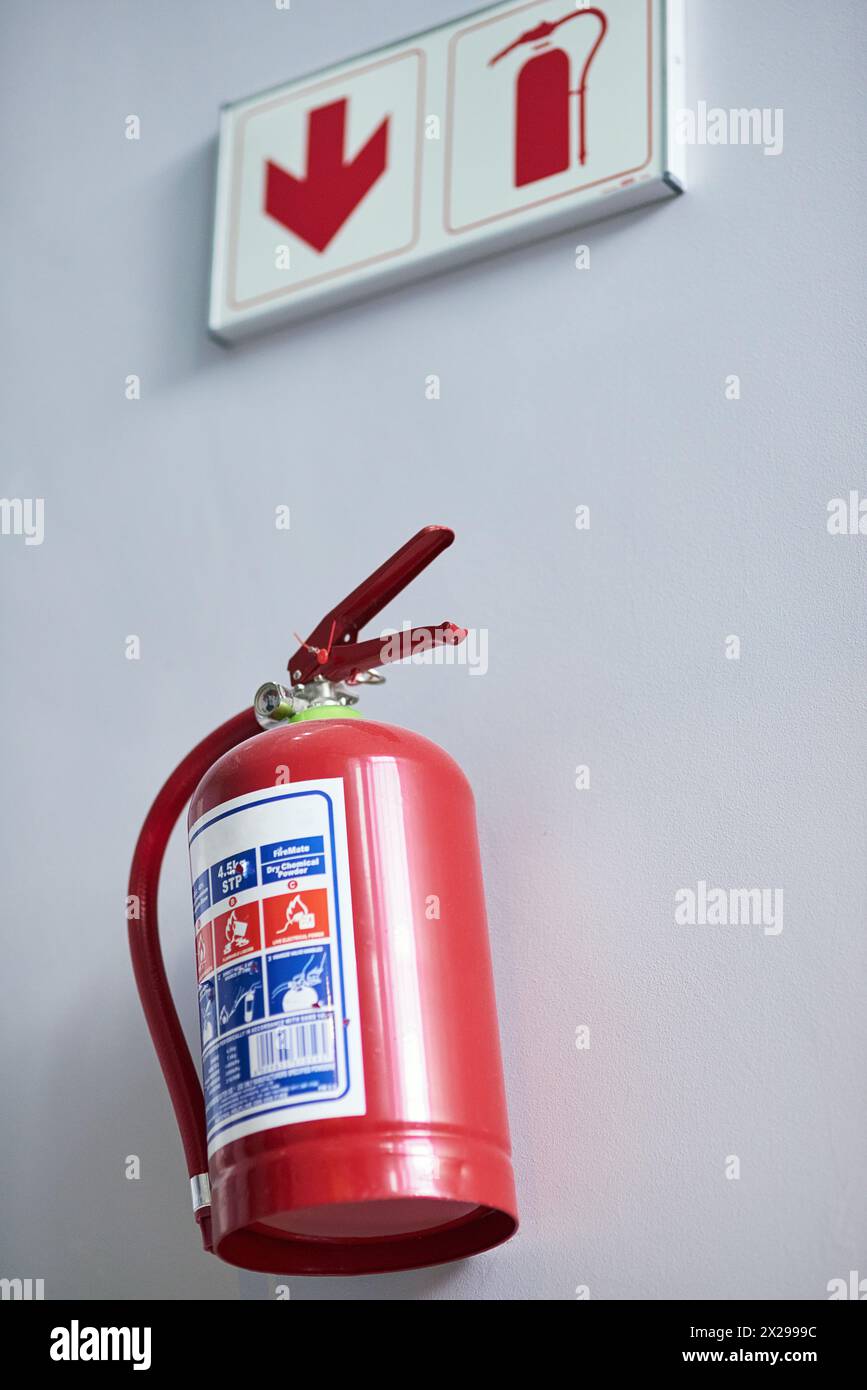 Fire extinguisher, wall and sign for firefighting, action and safety ...