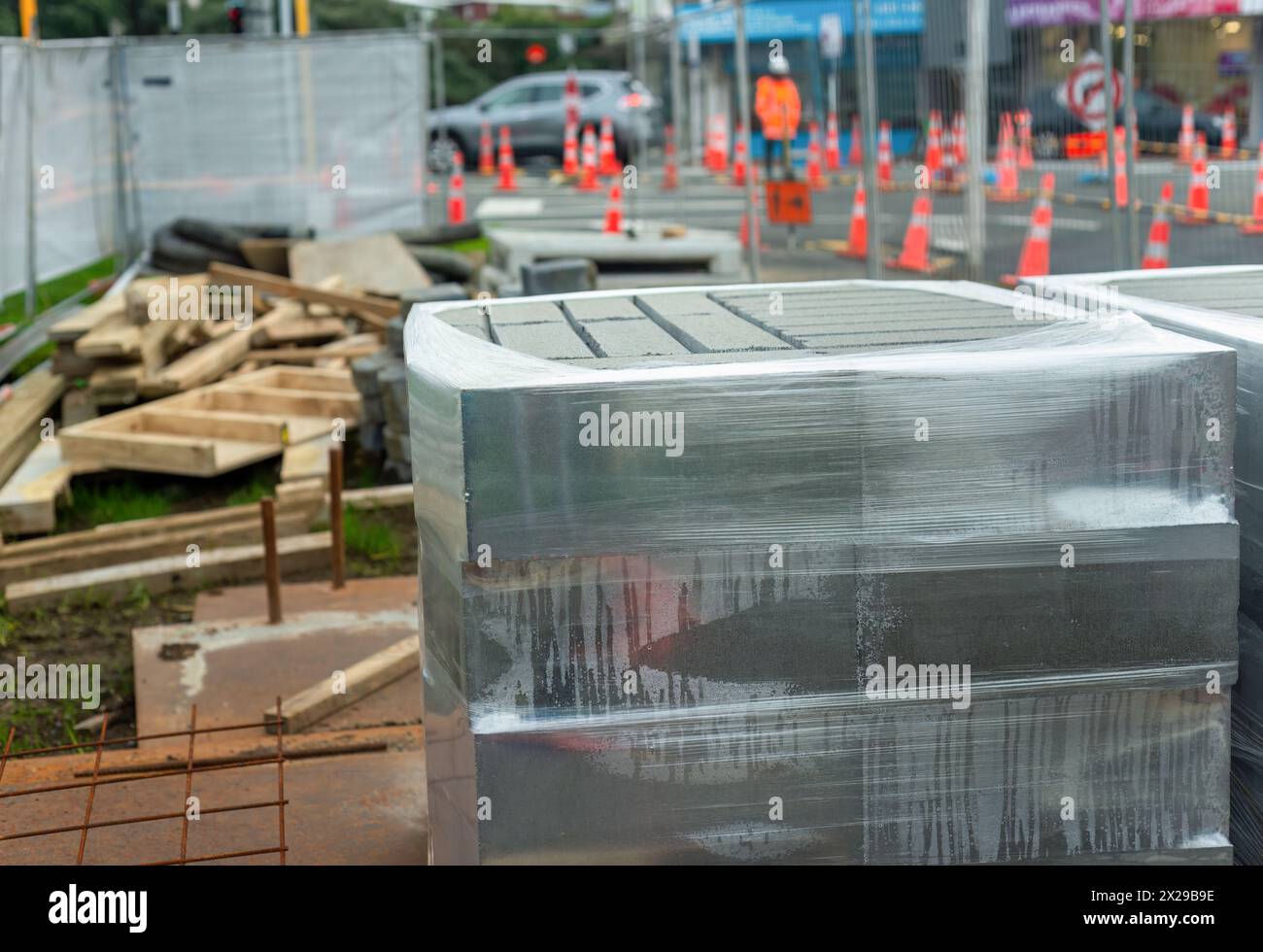 Bricks wrapped in plastic on a construction site. Unrecognizable worker ...