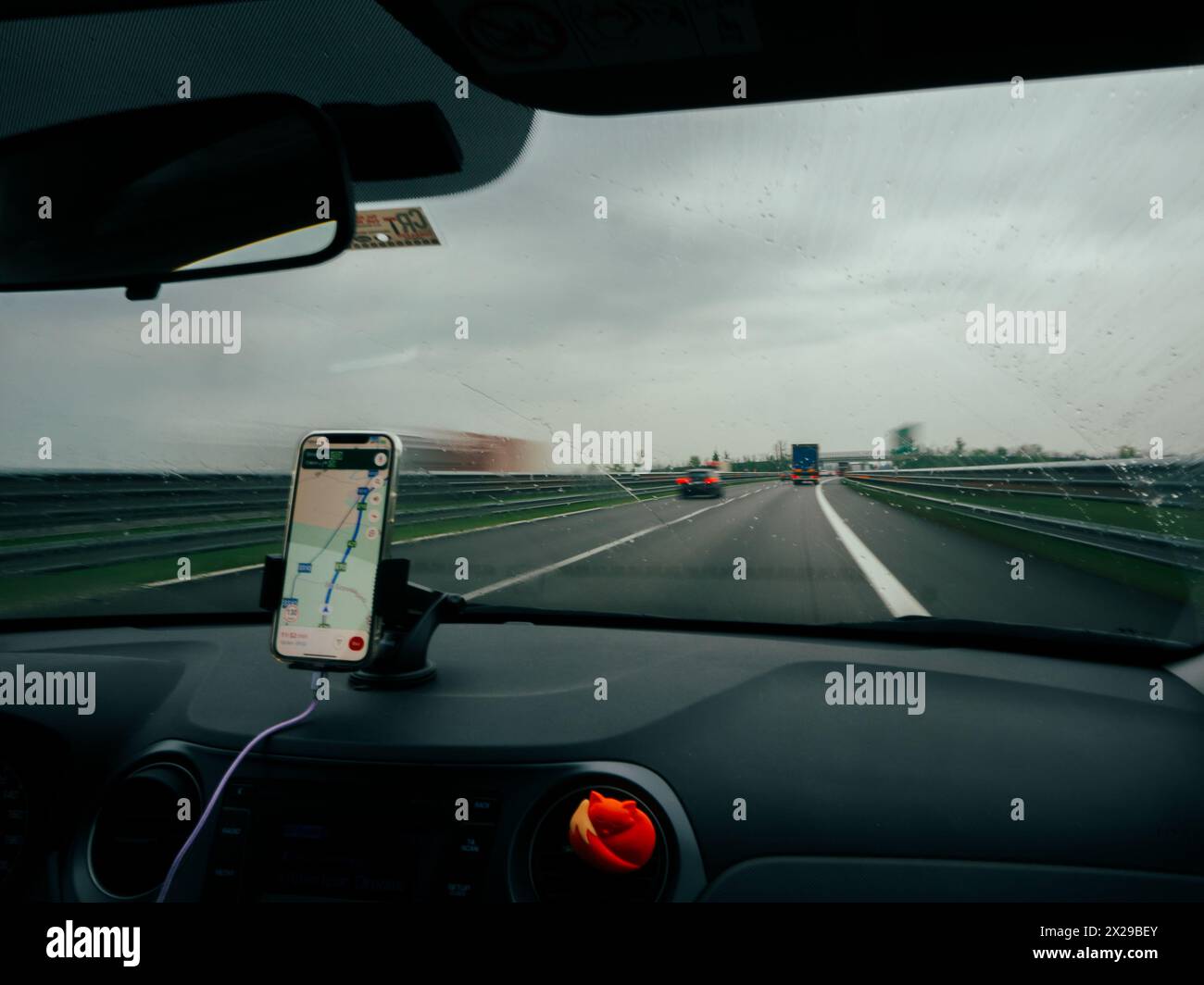 5g Smartphone displaying GPS navigation mounted on a car's dashboard ...