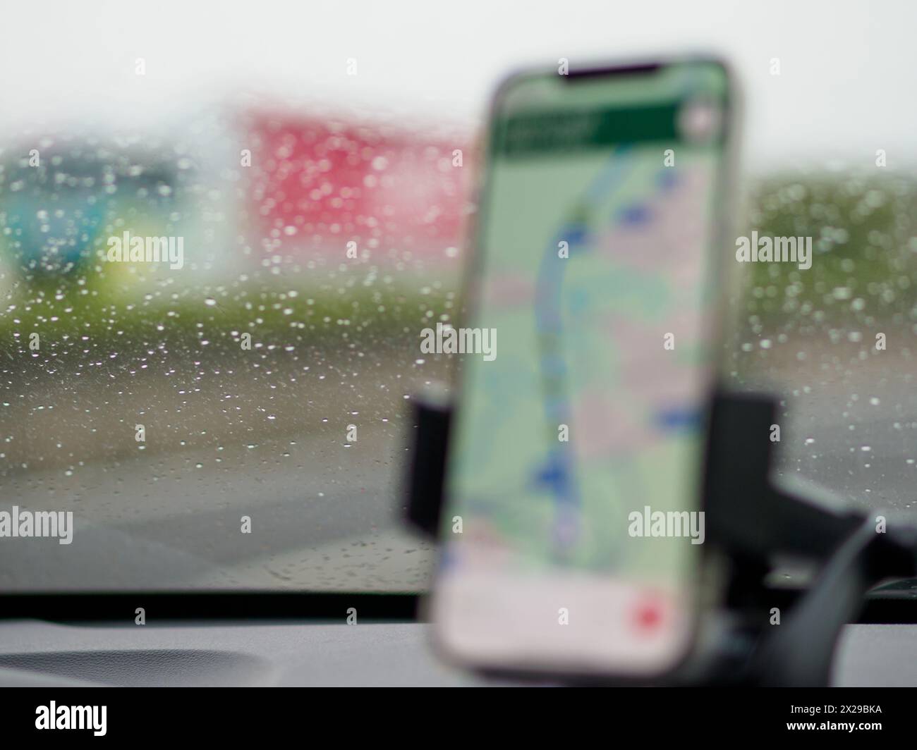 5g Smartphone displaying GPS navigation mounted on a car's dashboard ...