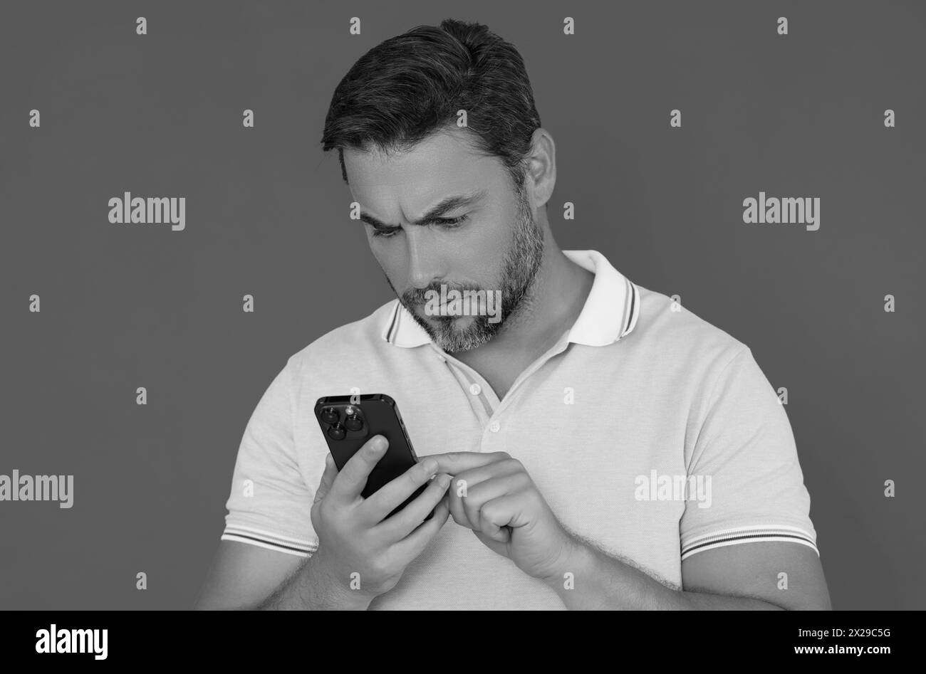 Portrait of handsome man using smartphone, chatting, making post on ...