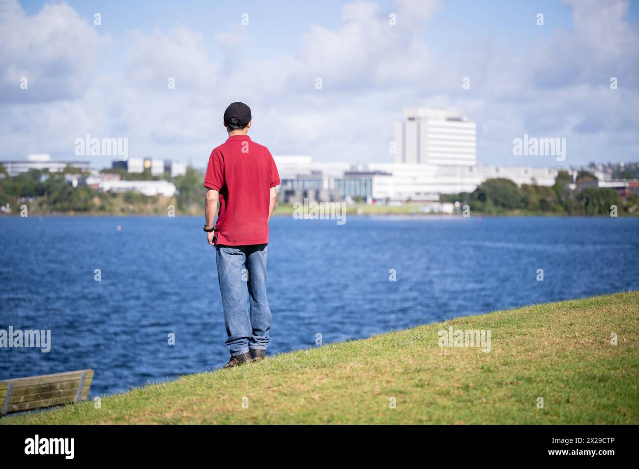 Man looking at the views across lake Pupuke. North Shore Hospital in ...