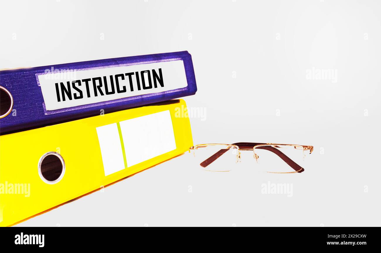 INSTRUCTIONS The word is written on a document folder with glasses on a ...