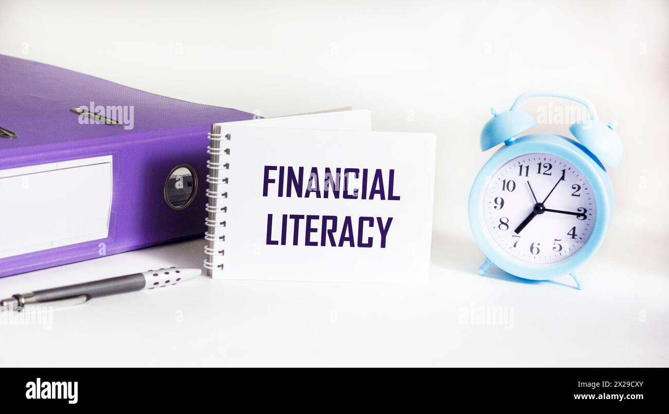 Financial literacy written on a piece of notepad and a white background ...