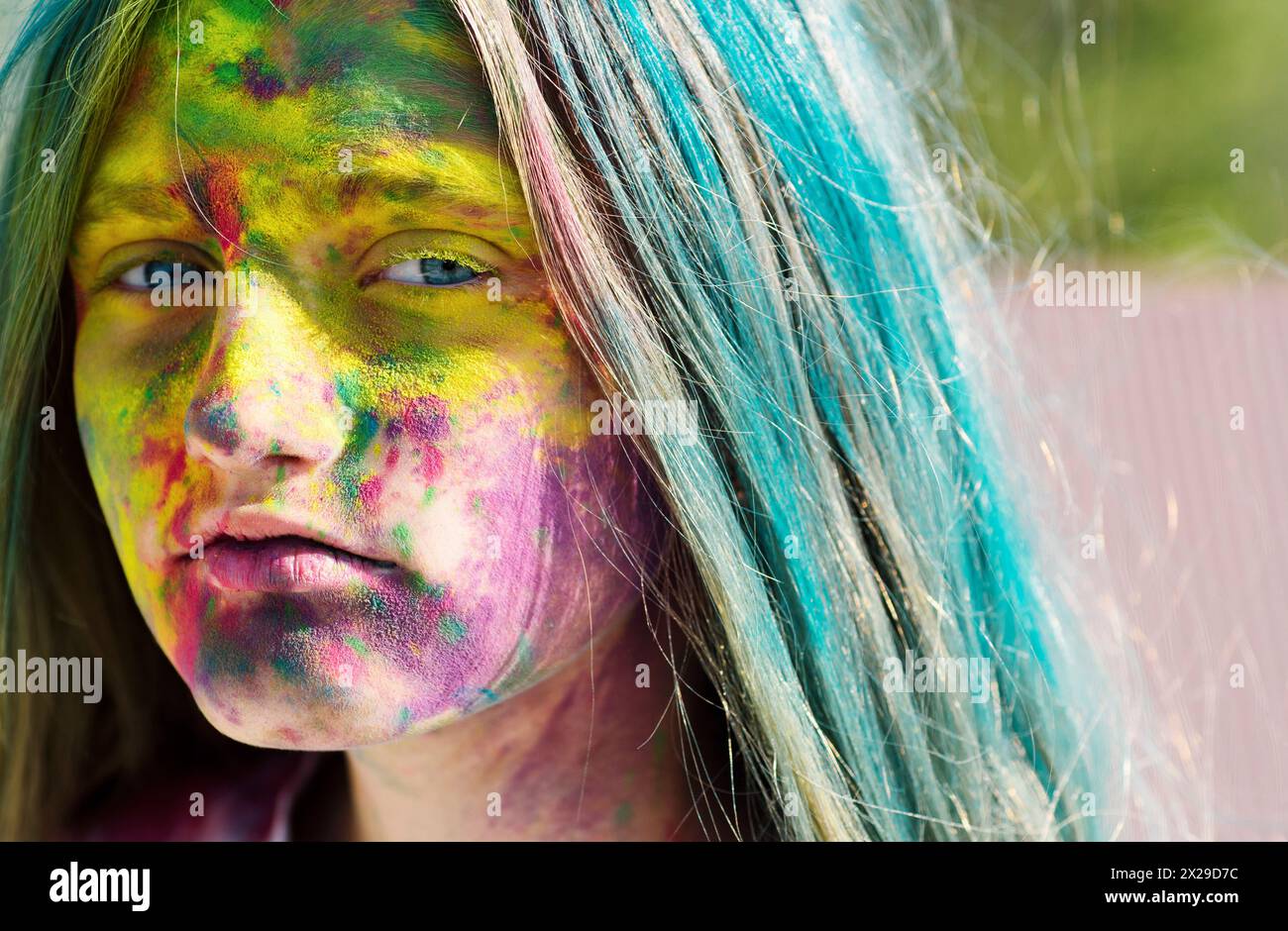 Dry color on face. Colorful holi on painted hair and face. Girls with ...