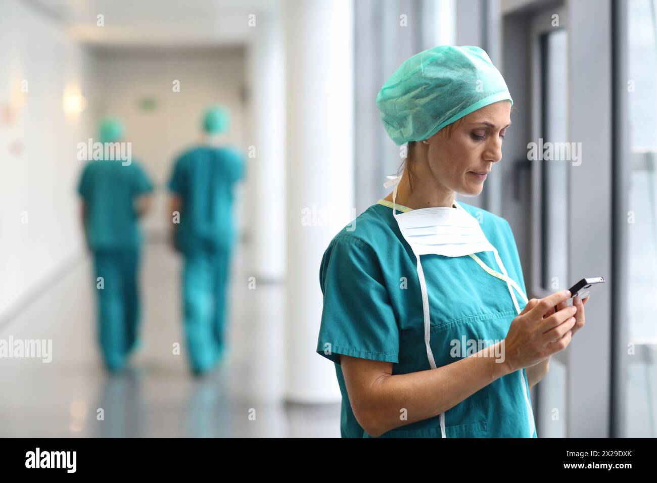 surgeon with smartphone in the operating room hallway, Onkologikoa ...