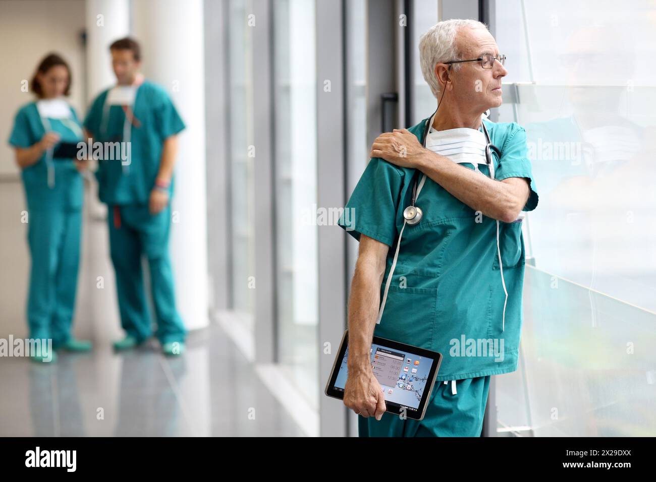 surgeon with tablet in the operating room hallway, Onkologikoa Hospital ...