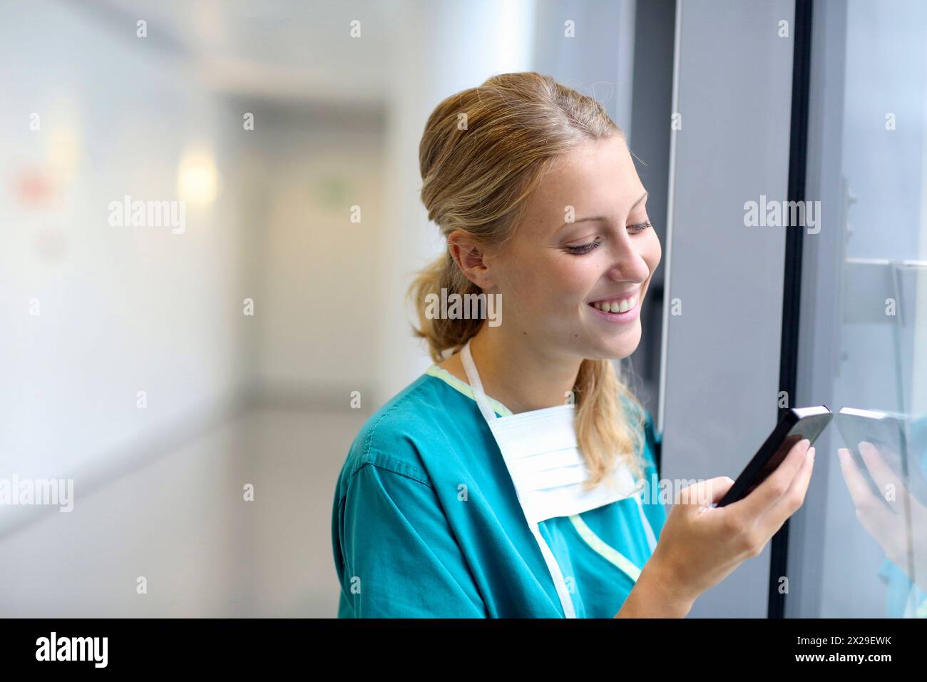 surgeon with smartphone in the operating room hallway, Onkologikoa ...