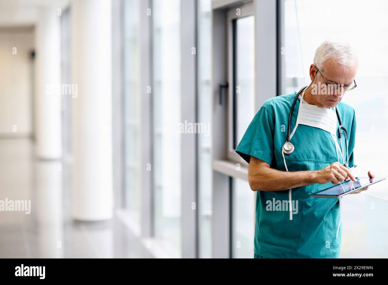 surgeon with tablet in the operating room hallway, Onkologikoa Hospital ...