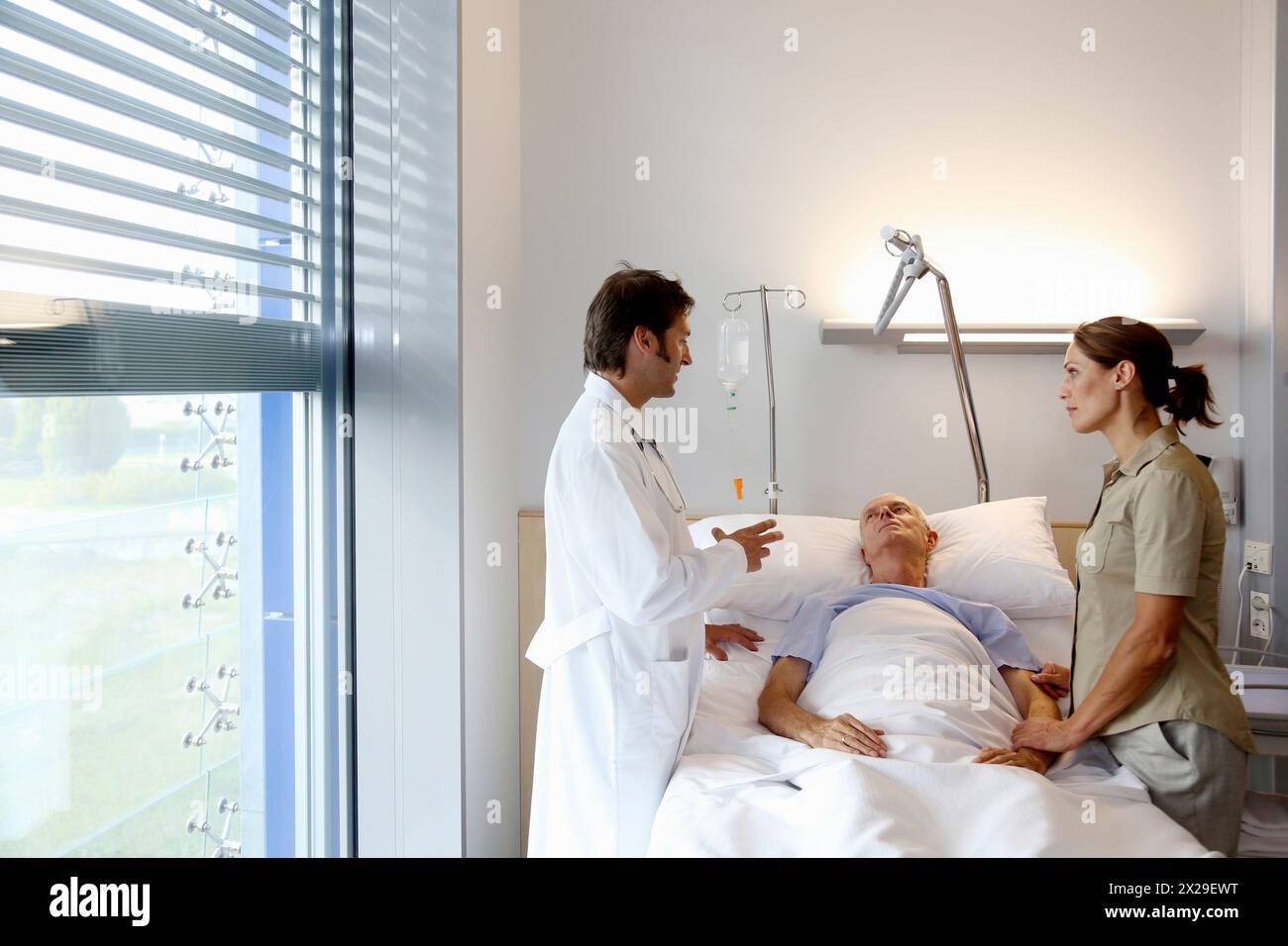 doctor attending to patient in hospital room, Onkologikoa Hospital ...