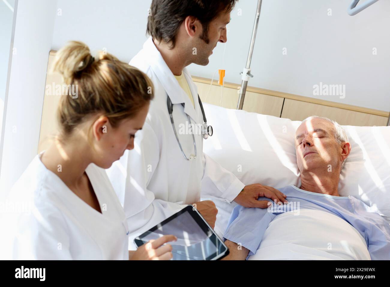 doctor attending to patient in hospital room, Onkologikoa Hospital ...